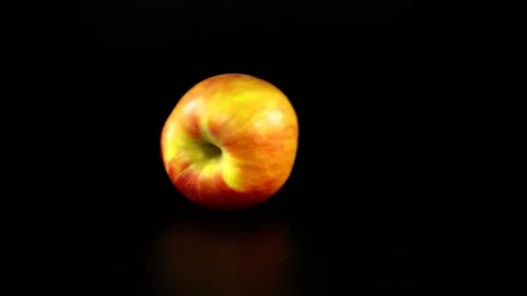 Sliding apple on a black background. | Stock Video | Pond5