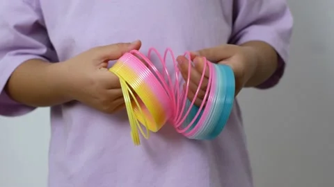 Slinky rainbow toy 90. The child plays w... | Stock Video | Pond5