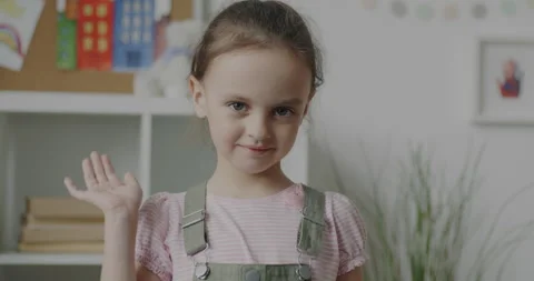 Slow motion of adorable kid waving hand ... | Stock Video | Pond5