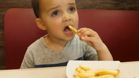 Slow motion of boys eating unhealthy fre... | Stock Video | Pond5