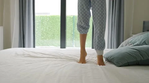 Slow motion of child's feet jumping on b... | Stock Video | Pond5