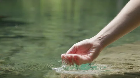SLOW MOTION CLOSEUP: Hand holding and po... | Stock Video | Pond5