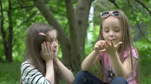 Slow Motion Cute little girls sitting on... | Stock Video | Pond5