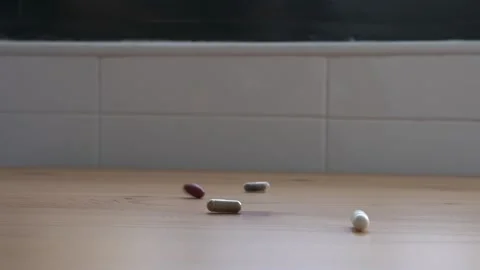 Slow motion of drugs falling on top of a... | Stock Video | Pond5