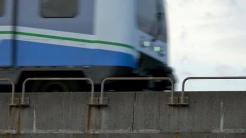 Slow motion elevated train travels over ... | Stock Video | Pond5