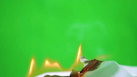 Slow motion fire flame burning on green ... | Stock Video | Pond5