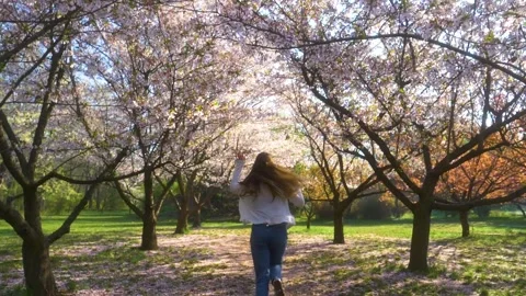 Slow motion girl running throug blossoms... | Stock Video | Pond5