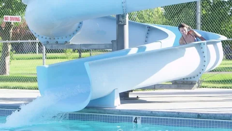 Slow motion girl sliding into the pool | Stock Video | Pond5