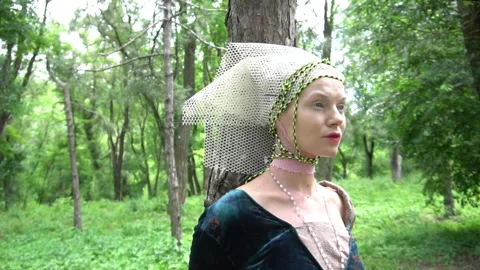 Slow Motion A girl tied to a tree in a f... | Stock Video | Pond5