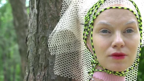 Slow Motion A girl tied to a tree in a f... | Stock Video | Pond5