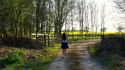 Slow motion of girl walking down path up... | Stock Video | Pond5