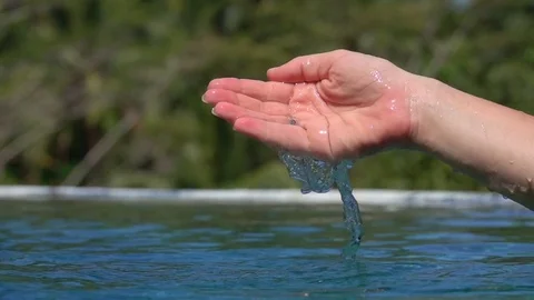 SLOW MOTION: Human hand scooping water, ... | Stock Video | Pond5
