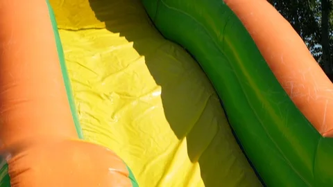Slow motion of the kids on water slide o... | Stock Video | Pond5
