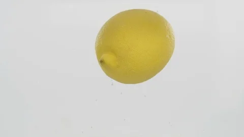 Slow motion. Lemon falling into water an... | Stock Video | Pond5