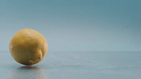 Slow Motion a Lemon Slice fall on blue b... | Stock Video | Pond5