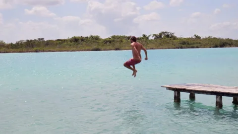 Slow motion: Man running and jumping fro... | Stock Video | Pond5
