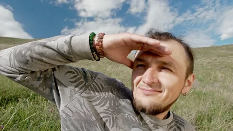 Slow motion of a man sitting in the gras... | Stock Video | Pond5