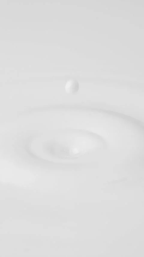 Slow motion of milk drop falling on milk... | Stock Video | Pond5