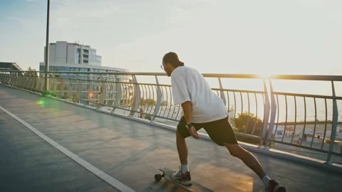 Slow motion of millennial guy riding lon... | Stock Video | Pond5