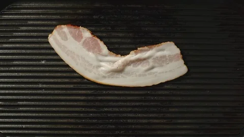 SLOW MOTION: One bacon slice falling to ... | Stock Video | Pond5