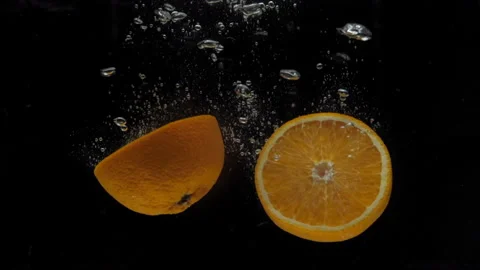 Slow motion orange halves falling into t... | Stock Video | Pond5