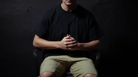Slow motion shot of a man sitting in a c... | Stock Video | Pond5