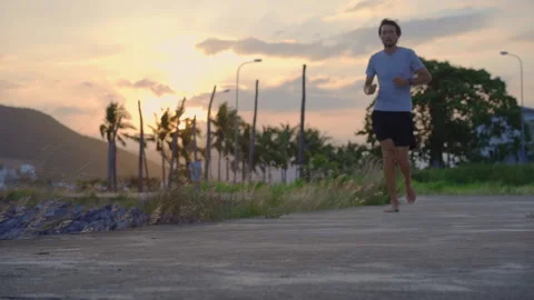 Slow Motion shot of a young man running ... | Stock Video | Pond5