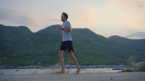 Slow Motion shot of a young man running ... | Stock Video | Pond5