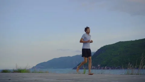 Slow Motion shot of a young man running ... | Stock Video | Pond5