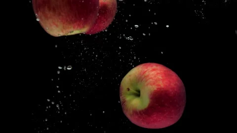 Slow motion three red apple falling into... | Stock Video | Pond5