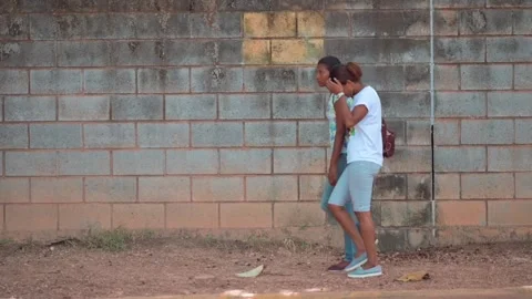 Slow motion of two friends walking on th... | Stock Video | Pond5