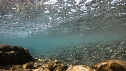 Slow motion underwater view of rock fall... | Stock Video | Pond5