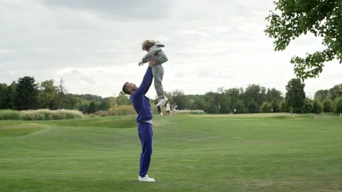 A slow-motion video of a father tossing ... | Stock Video | Pond5
