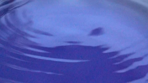 Slow Motion water drops splash into wate... | Stock Video | Pond5