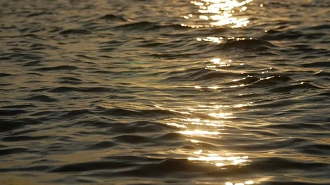 Slow motion. Wavy lake surface at sunset... | Stock Video | Pond5