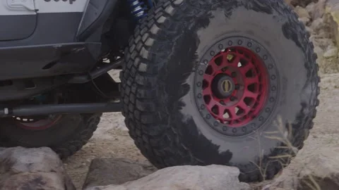 Slow motion of wheel on jeep four wheeli... | Stock Video | Pond5