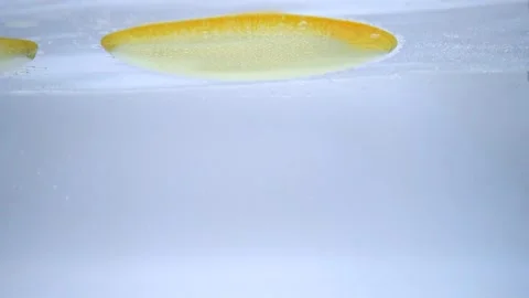 Slow Motion Yellow oil floating on water... | Stock Video | Pond5