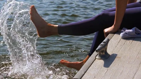 slow motion young woman sitting on a doc... | Stock Video | Pond5