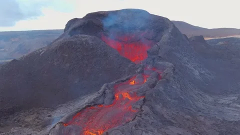 Slow tilt down of lava flowing from the ... | Stock Video | Pond5