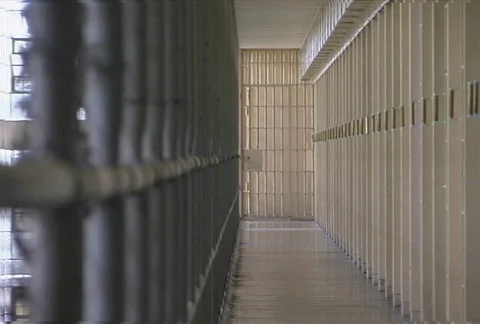 Slow zoom-out from end of prison cellblo... | Stock Video | Pond5
