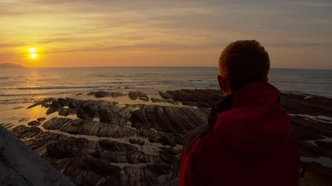 Slow zoom in woman contemplates sunset | Stock Video | Pond5