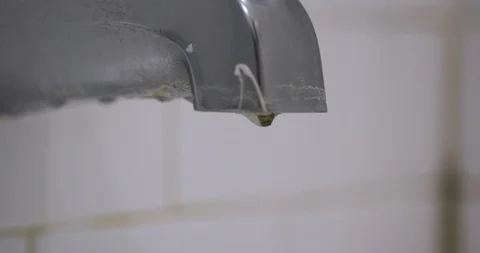Slowly dripping bath tap with white tile... | Stock Video | Pond5
