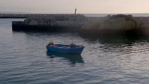 A small boat bobbing around on the sea i... | Stock Video | Pond5