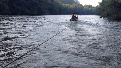 A small boat dragged behind a passenger ... | Stock Video | Pond5