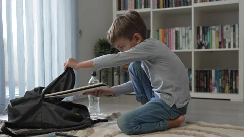 Small boy pupil child prepare his backpa... | Stock Video | Pond5