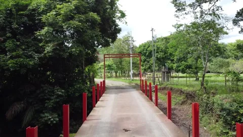 Small bridge with red metallic bars surr... | Stock Video | Pond5