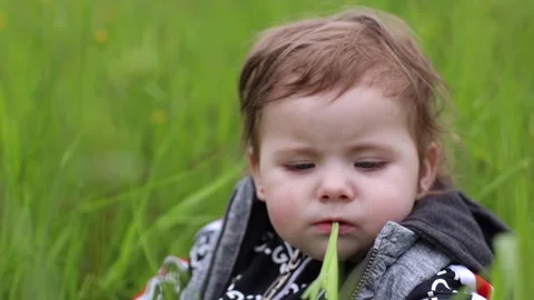 A small child, 1 year old, is sitting in... | Stock Video | Pond5