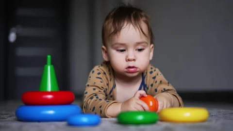 Small child playing with colored toys. L... | Stock Video | Pond5