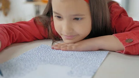 small girl drawing doodles on paper with... | Stock Video | Pond5