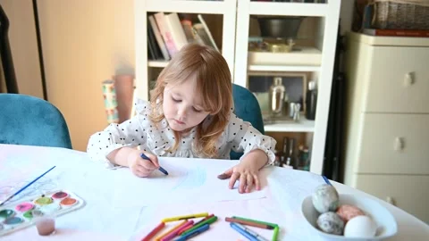 Small girl sitting at table drawing on p... | Stock Video | Pond5